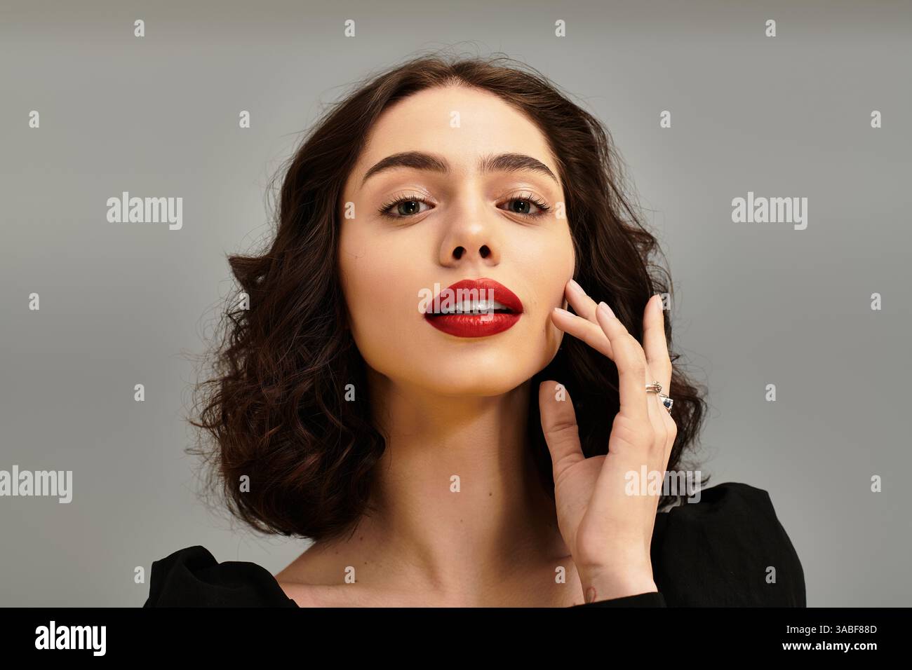 A beautiful young woman showcases her radiant red lips and braces while ...