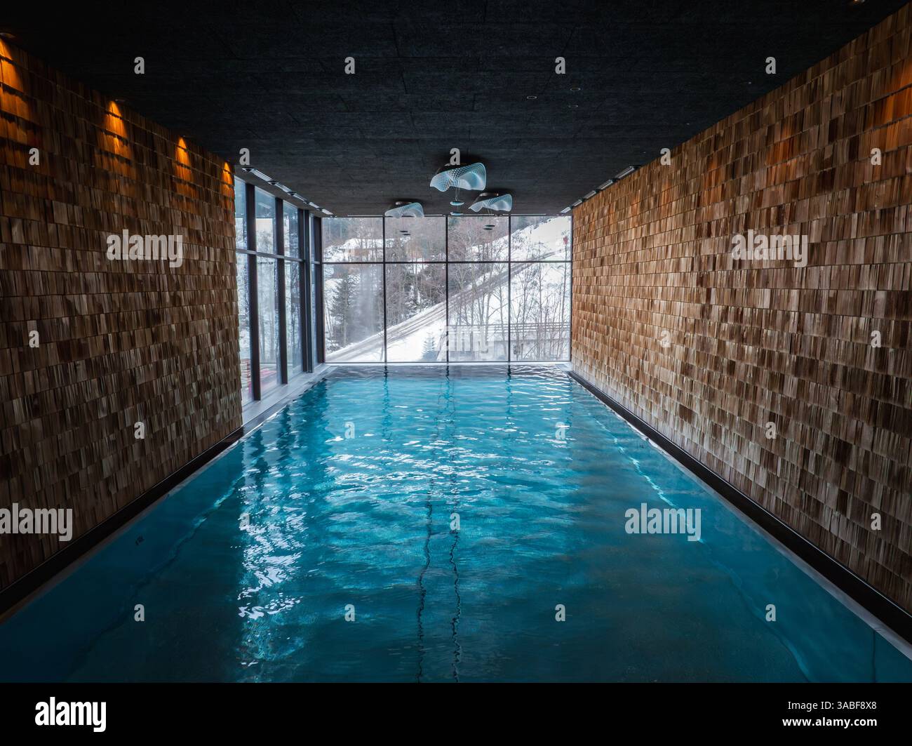 Indoor Pool with Wooden Paneling and Snowy Landscape Views Stock Photo ...
