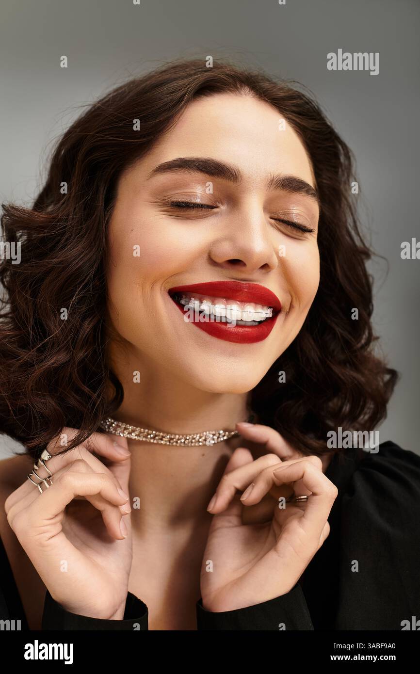 A joyful young woman beams with a captivating smile, showing off her ...