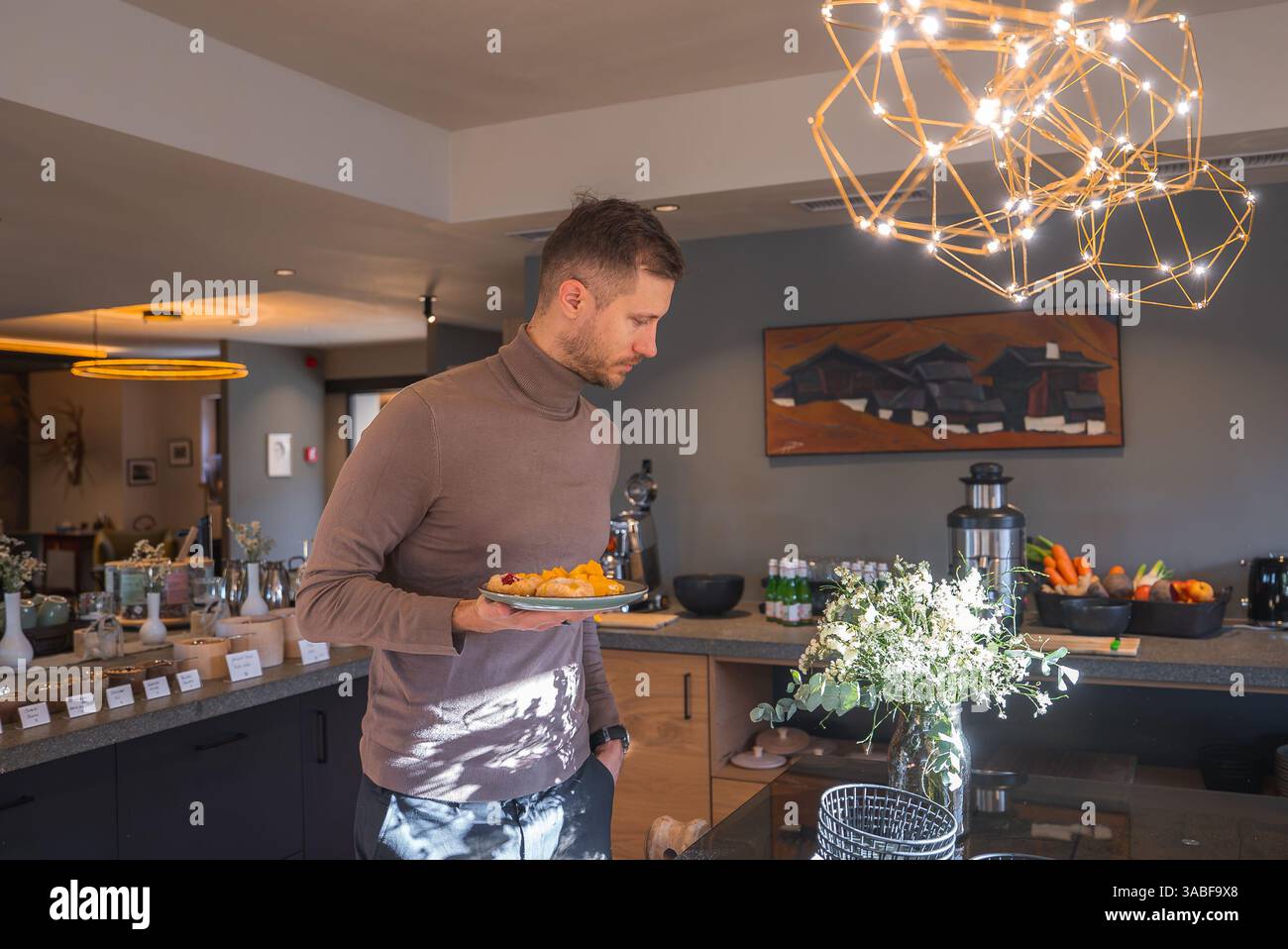 Man Holding Plate in Modern Dining Area with Buffet in South Tyrol ...