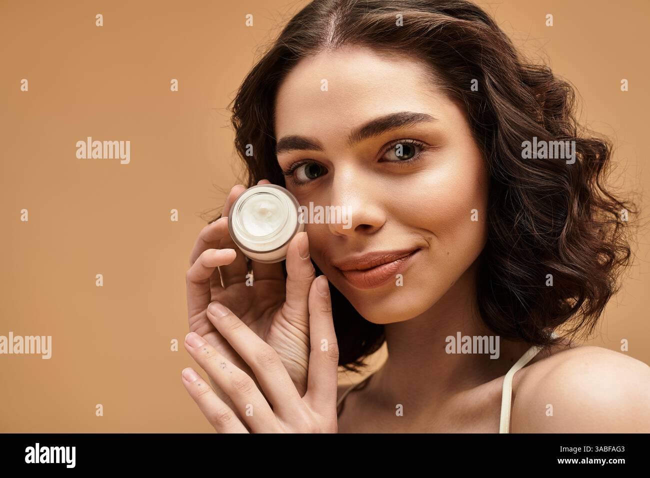 Pretty young woman demonstrates her beauty routine while showcasing her ...