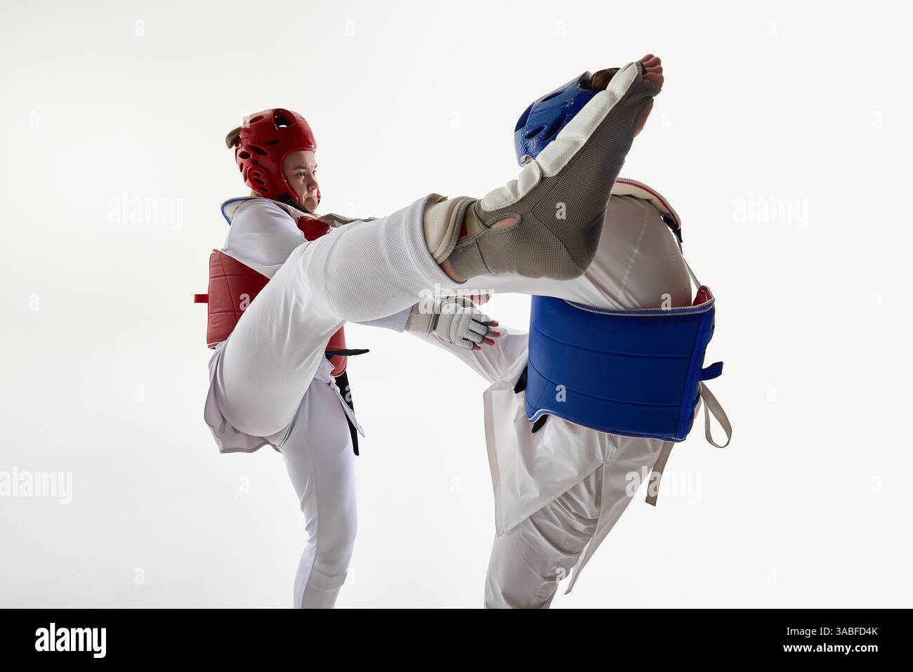 Red and blue taekwondo female fighters locked in intense close-range ...
