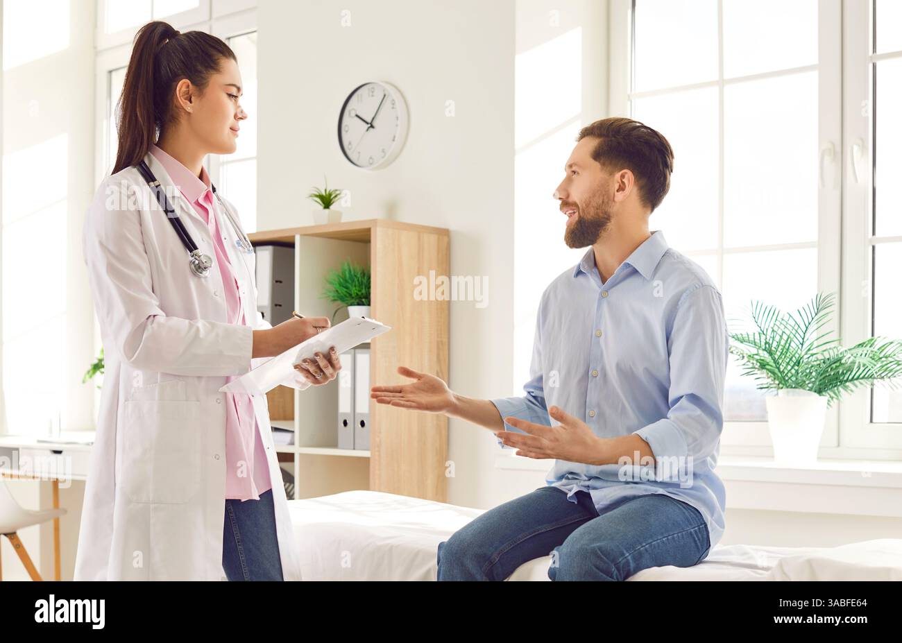 Female doctor, consulting male patient in medical office describing ...