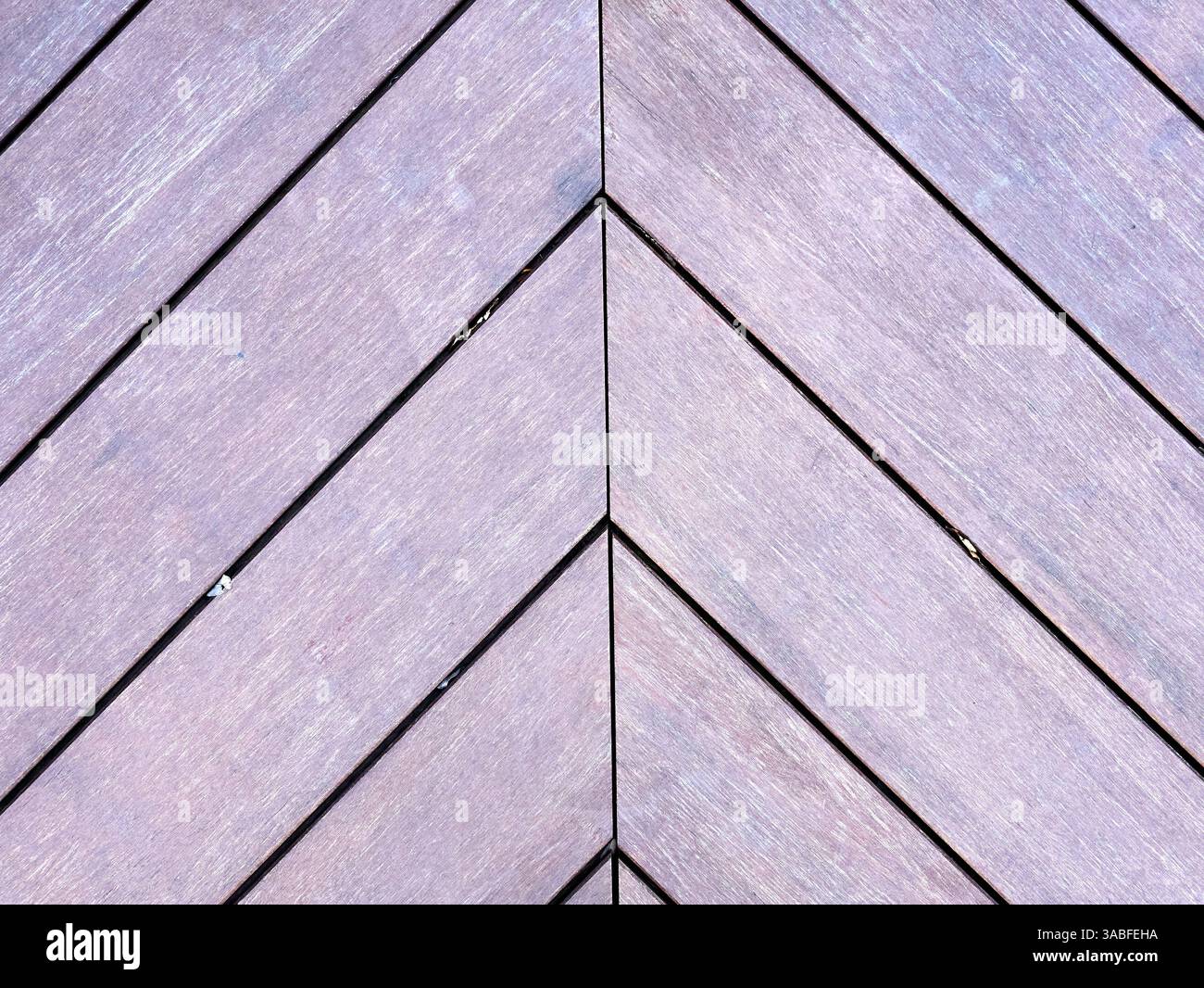 Wooden floor with a chevron pattern. The chevron pattern is made up of ...