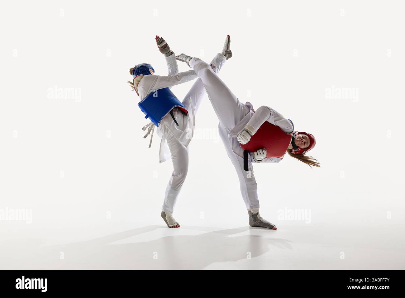 Competitive young women, taekwondo fighters in dynamic motion, training ...