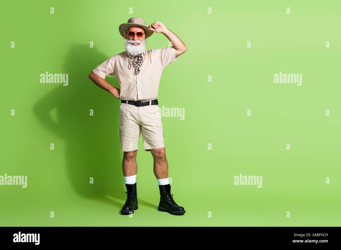A stylish explorer in safari clothing stands confidently against a ...