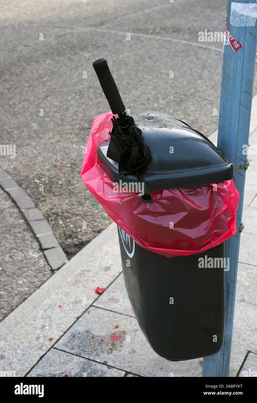 broken umbrella sticking out of a trash bin Stock Photo - Alamy