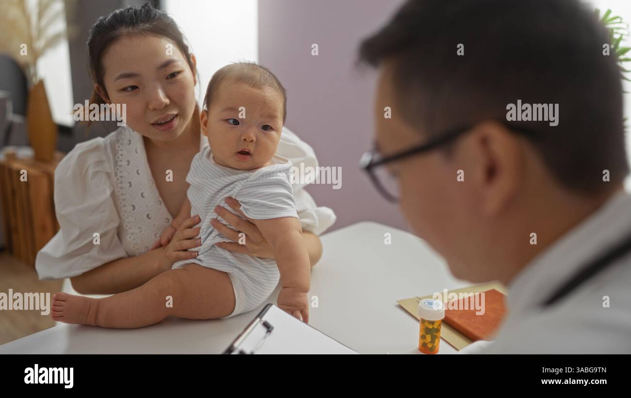 Pediatrician consulting mother and baby boy in a clinic room indoors ...
