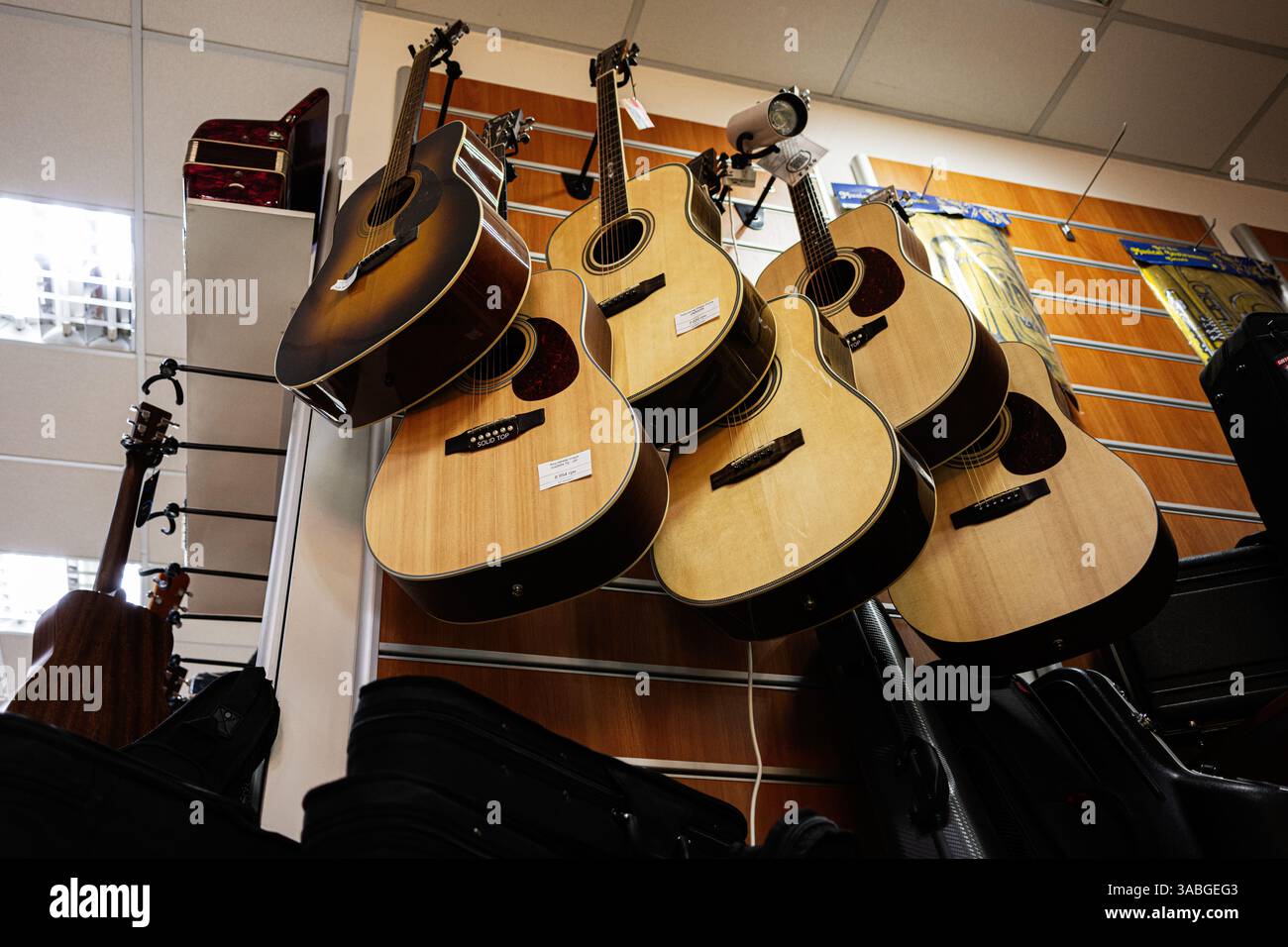 Lviv, Ukraine - April 01, 2025: Wooden acoustic guitars arranged on a ...