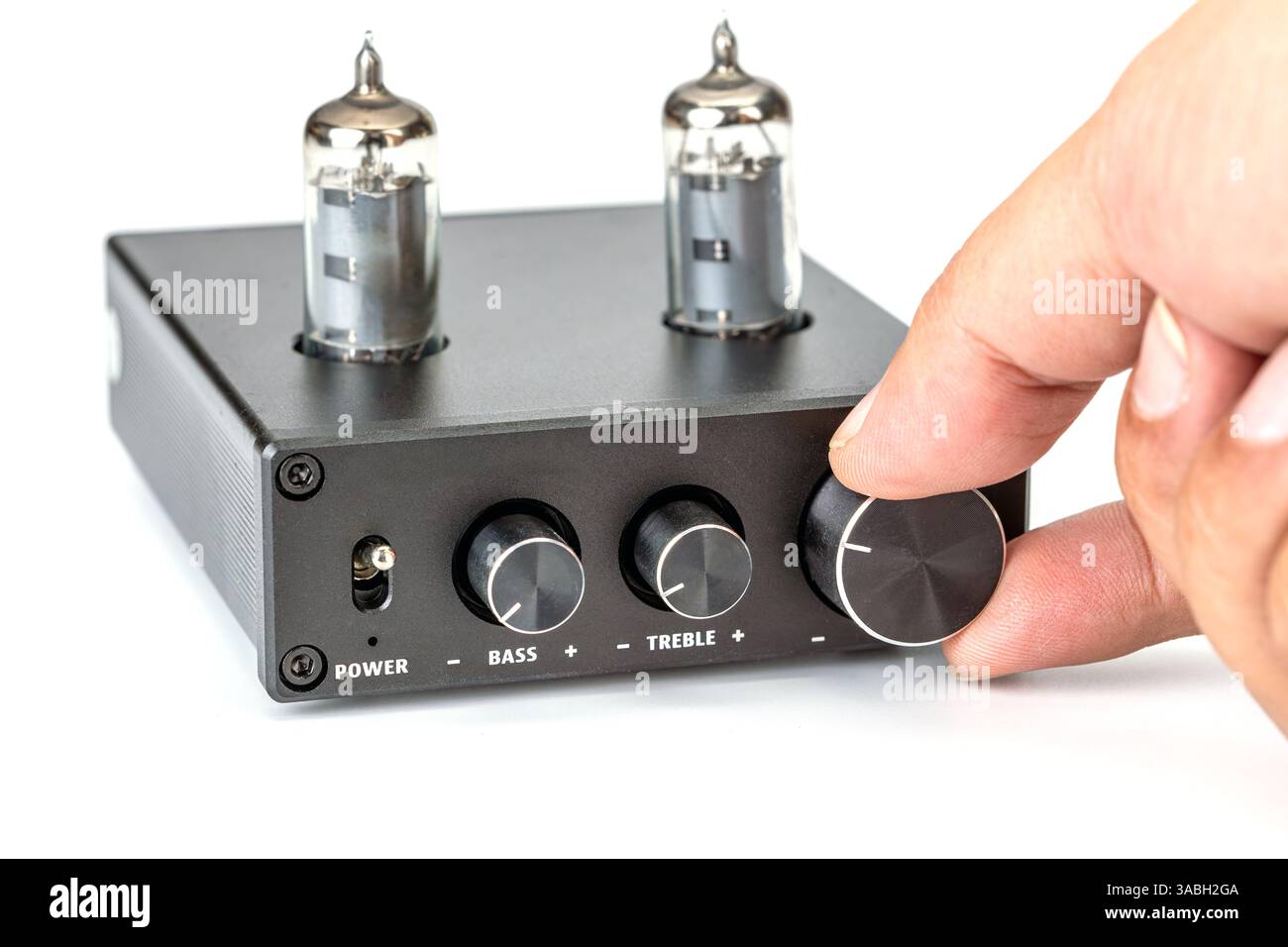 Fine tuning of a tube amplifier: Focused shot of a person adjusting the ...