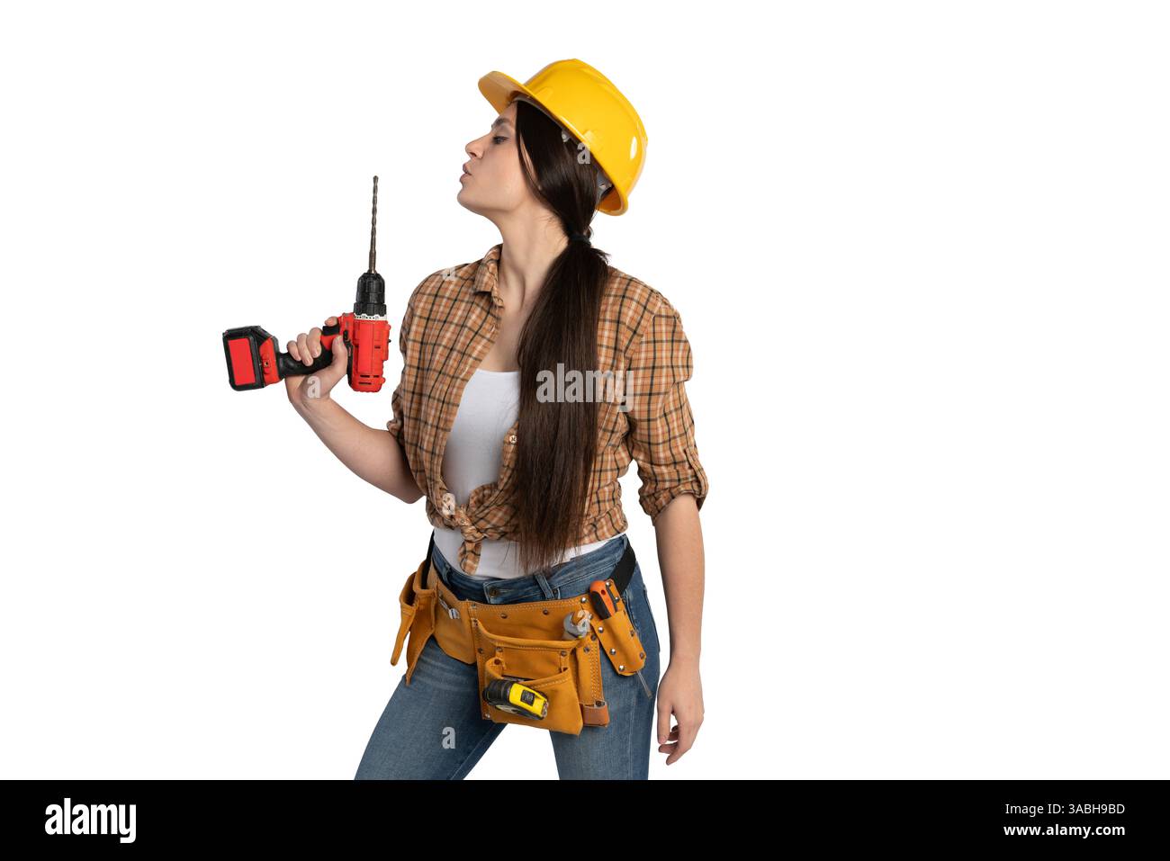 A female construction worker wearing a yellow hard hat and tool belt ...