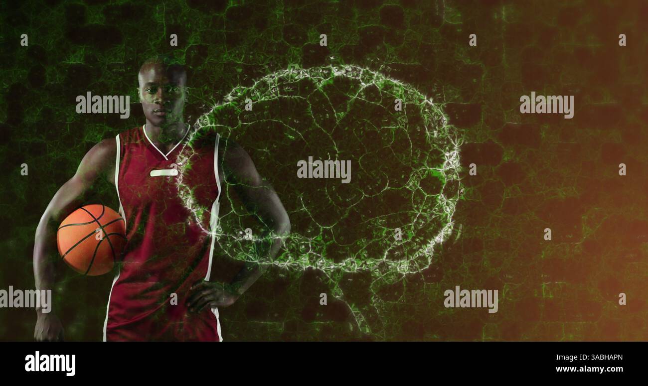 Image of digital brain spinning over male basketball player holding ...