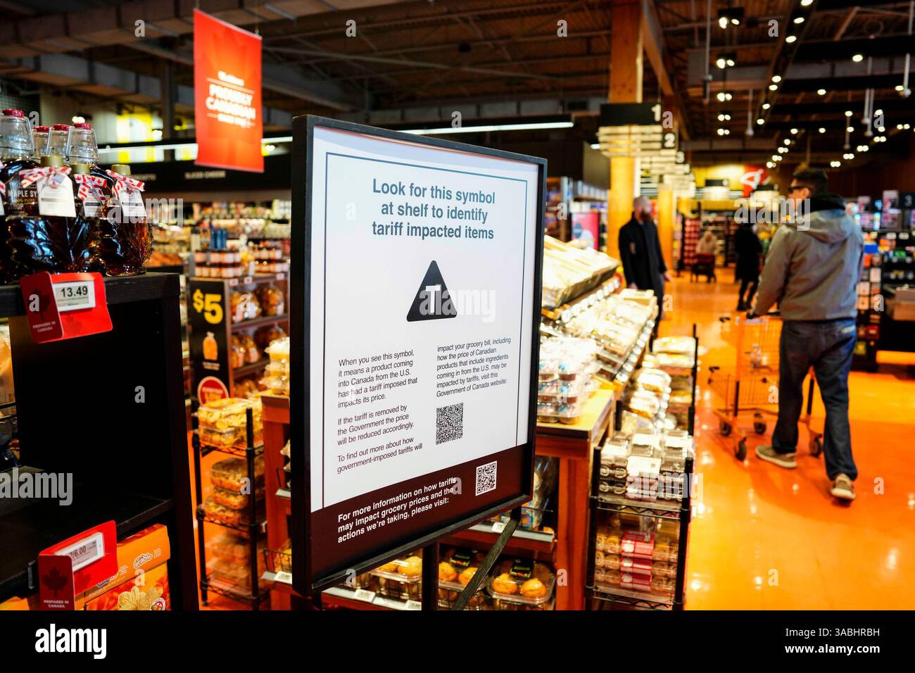A sign advising that products from the U.S. affected by a tariff will ...