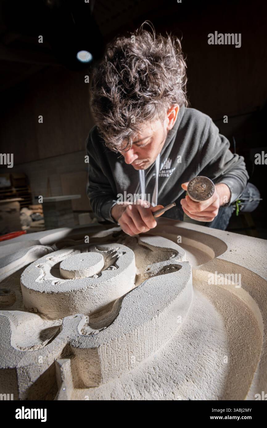Louis Clark, a partner of Established Stone, chisels out a tudor design ...