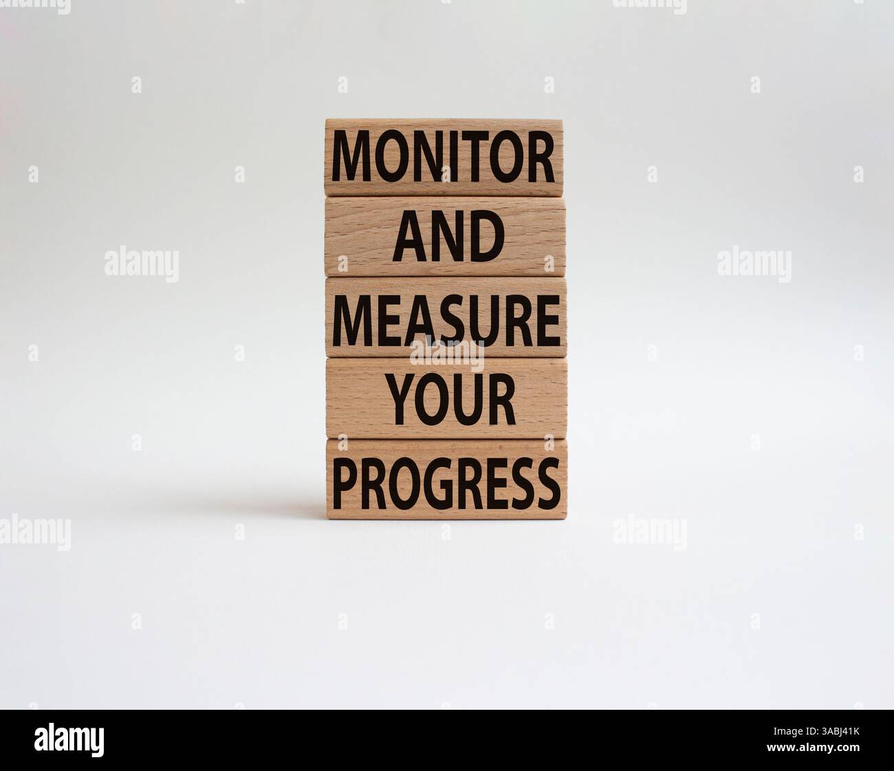 Monitor and Measure your Progress symbol. Wooden blocks with words Monitor and Measure your ...