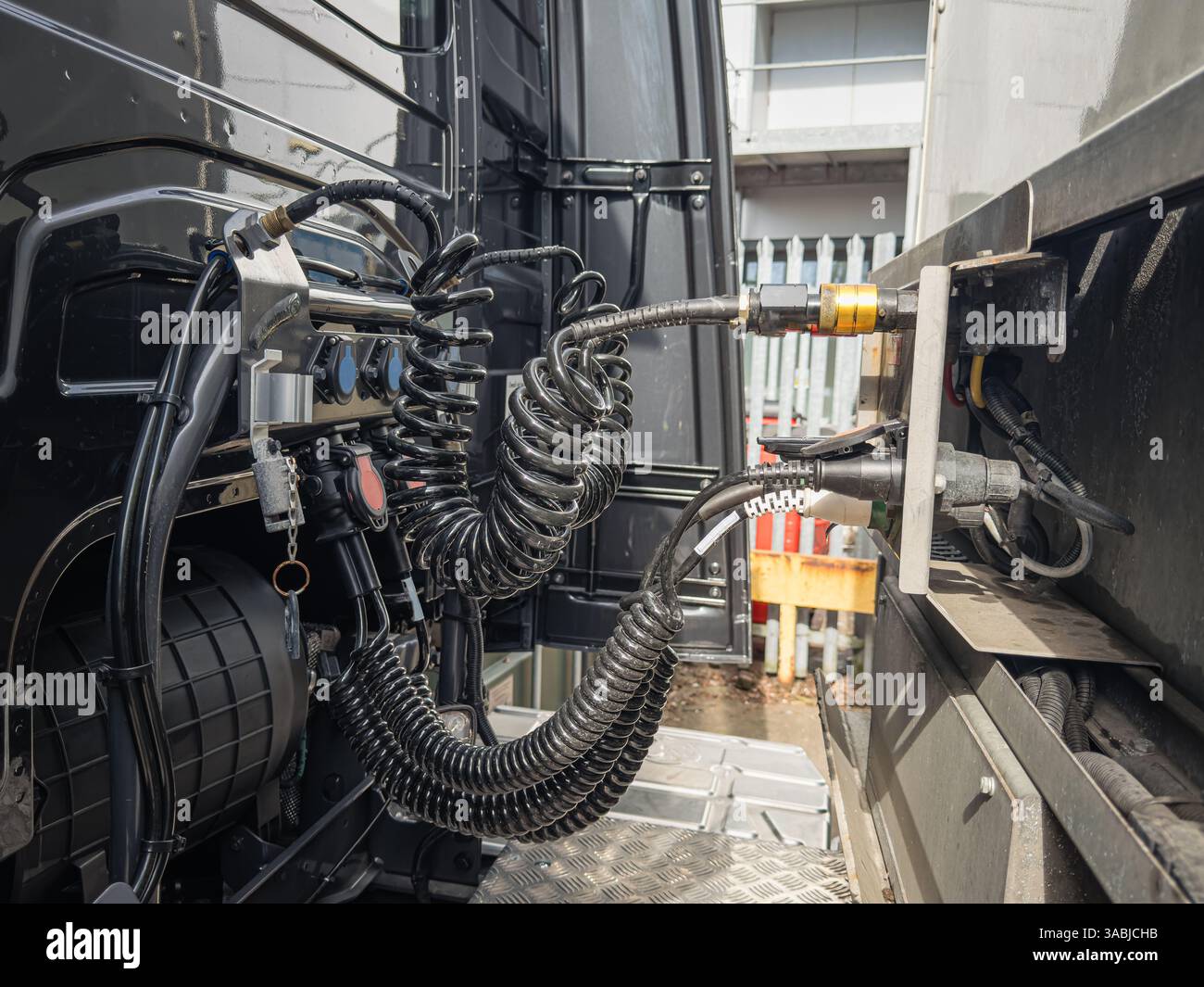 Close-up view of a fifth wheel coupling system and electric cables on a ...
