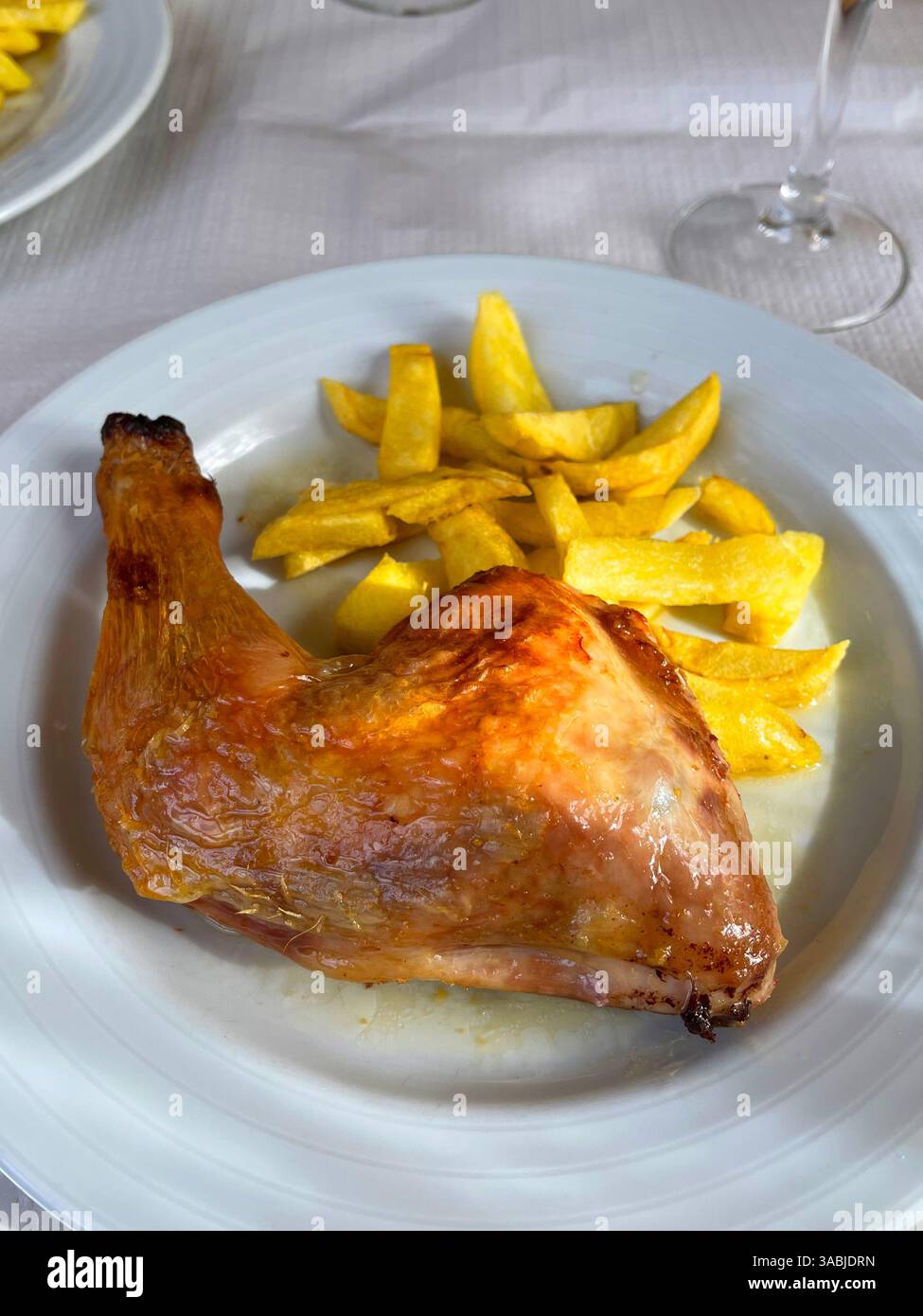 Roasted chicken leg with chips Stock Photo - Alamy