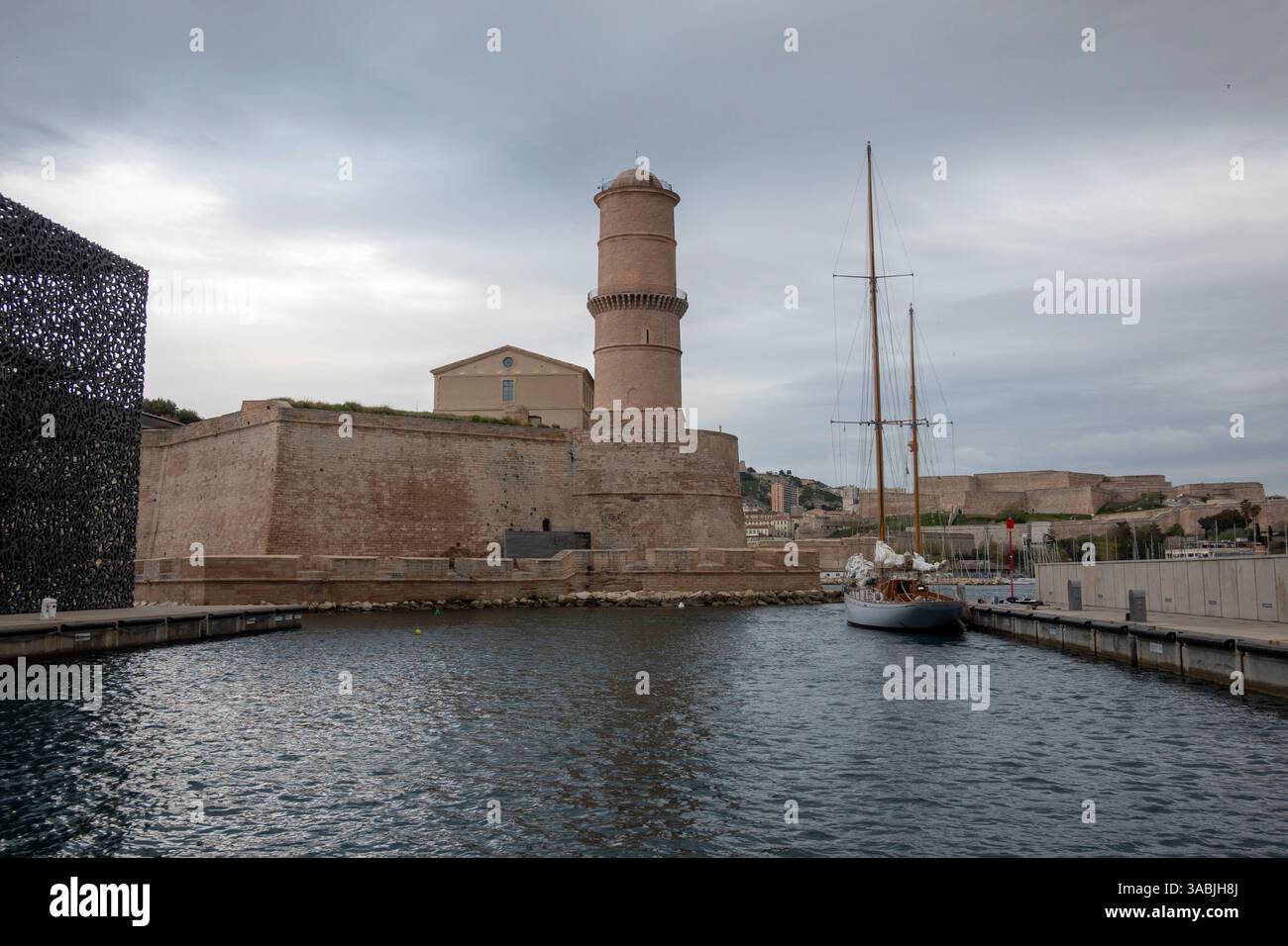 A nice sailboat sailing in Vieux Port next to the Fanal tower located ...