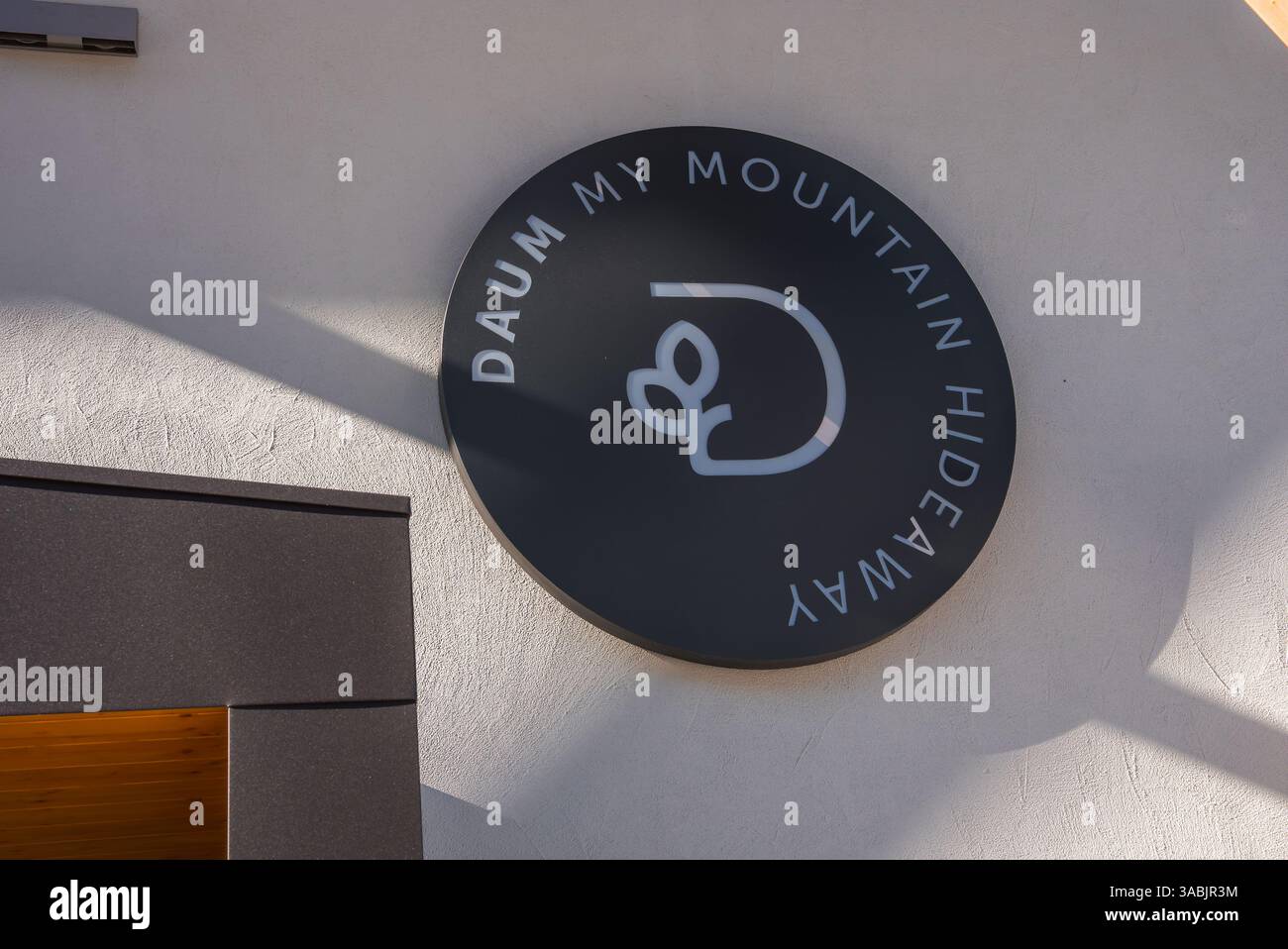 Circular Sign with Daum My Mountain Hideaway Logo on Wall Stock Photo ...
