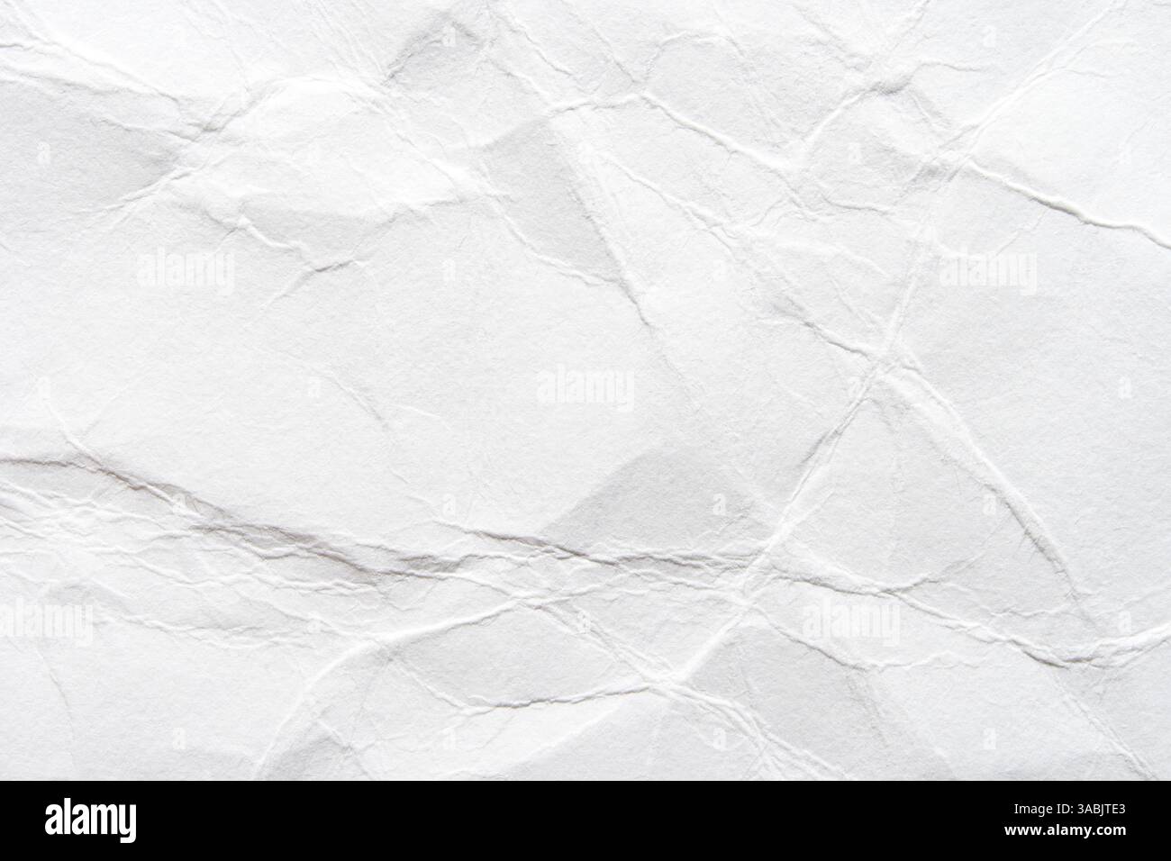 Close-up of textured white crumpled paper background with subtle folds ...