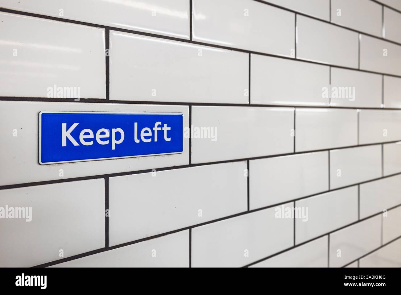 Keep Left sign on white tiled wall inside London Underground station ...
