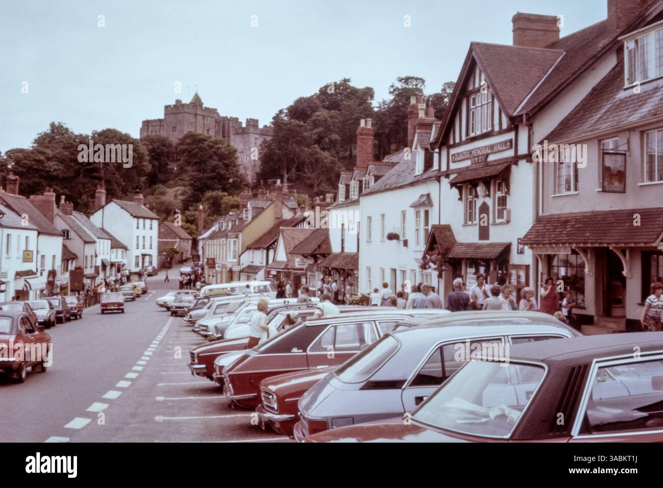 Dunster village High Street, with Dunster Castle and Dunster Memorial ...