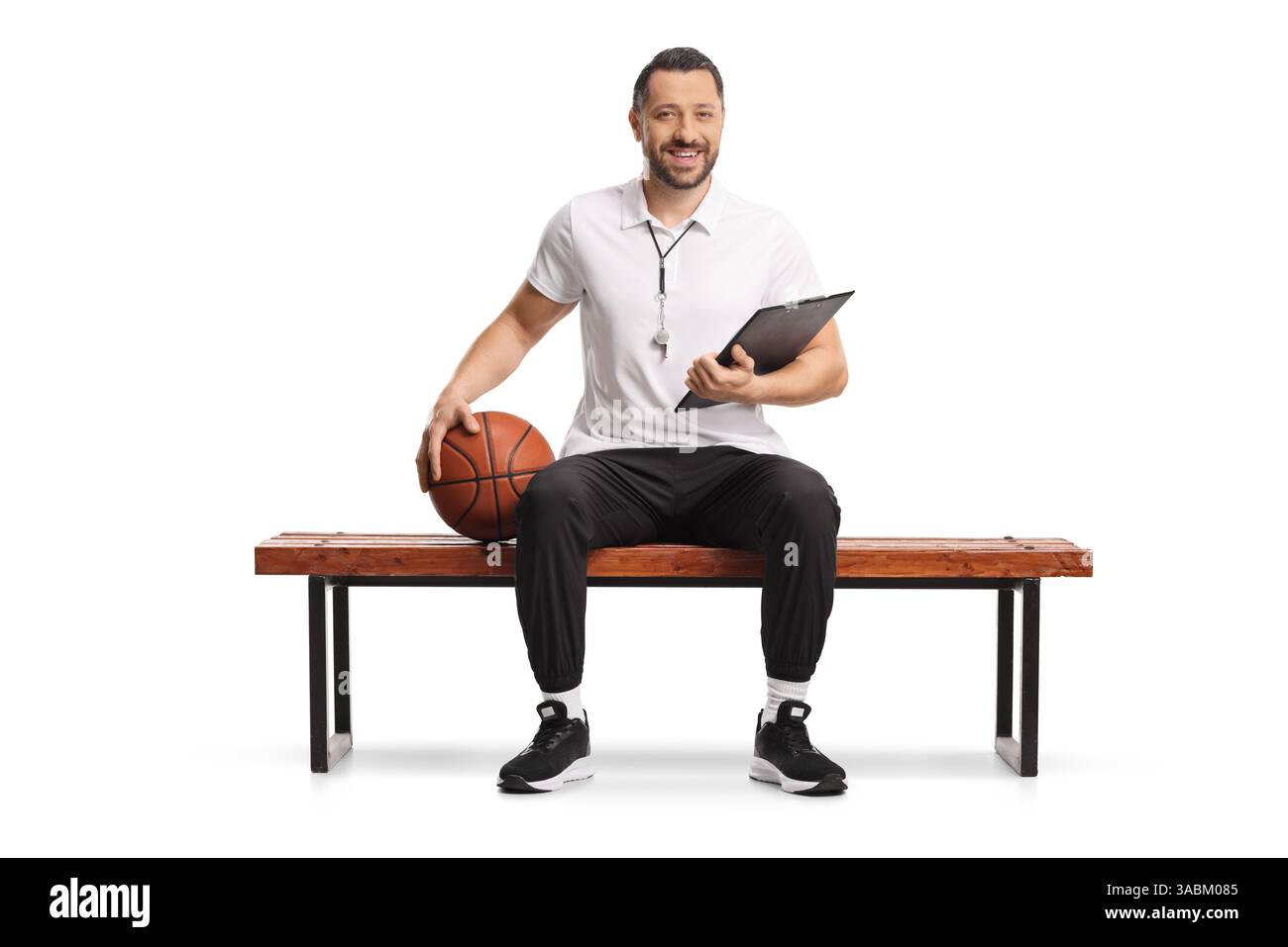 Basketball coach holding a ball and sitting on a bench isolated on ...