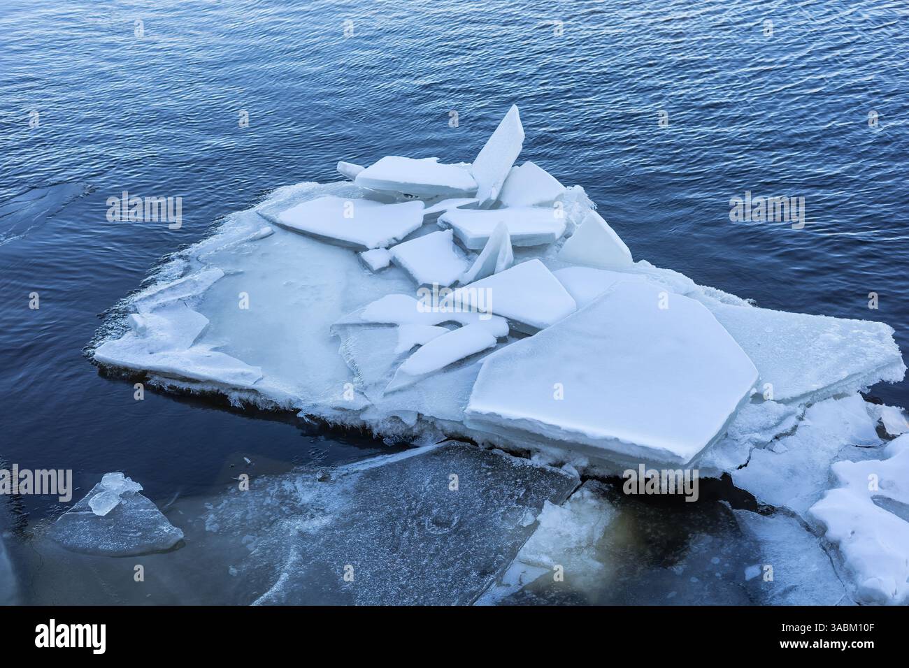 Broken ice floe floating on the water surface Stock Photo - Alamy