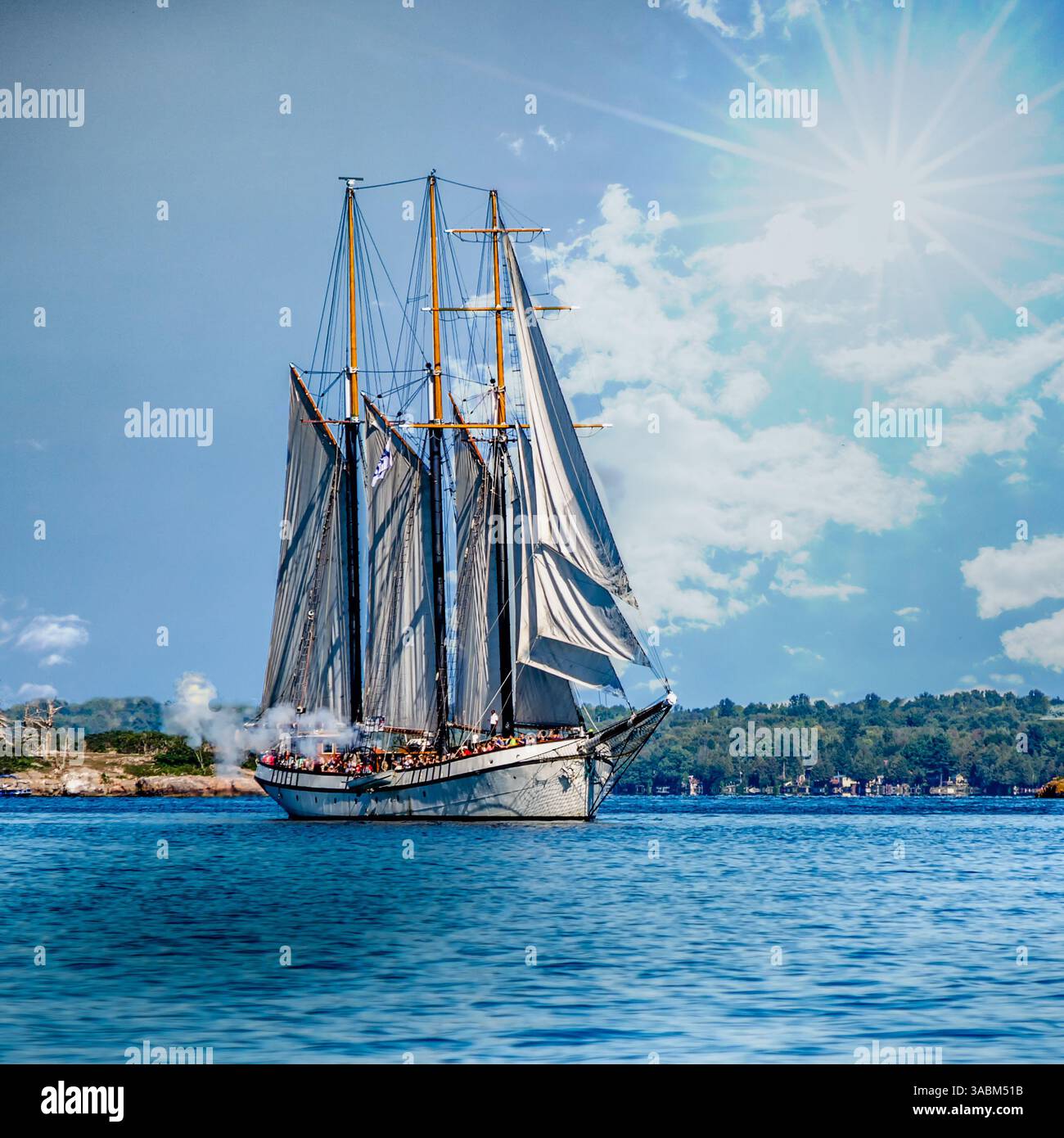 a white tall ship firing canon while under full sail against a ...