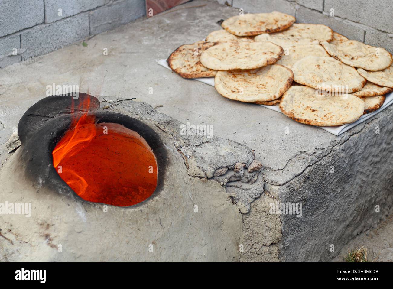 Baking bread in a tandoor oven using the traditional method in Hatay ...