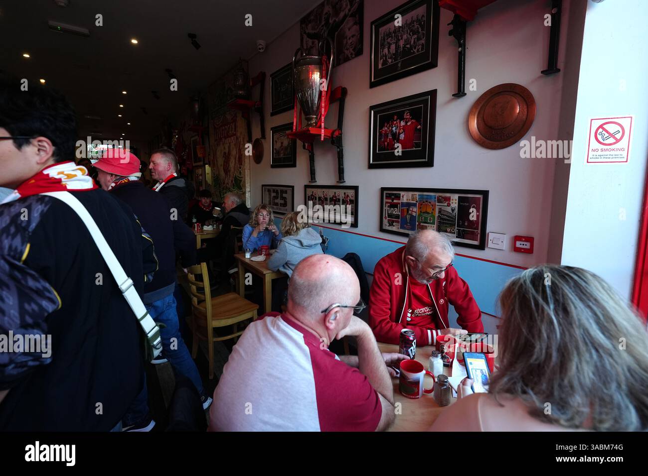 Liverpool fans inside a cafe ahead of the Premier League match between ...