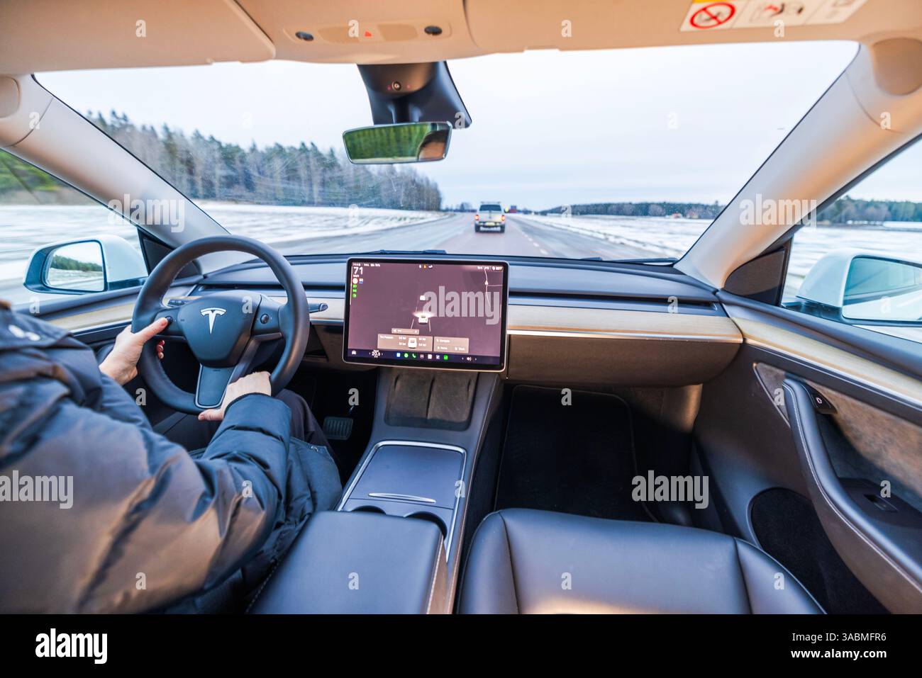 Woman driving tesla model autopilot hi-res stock photography and images ...