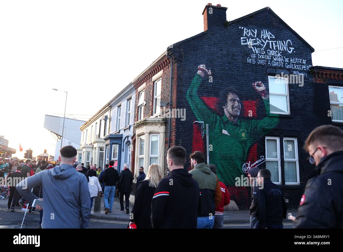 Liverpool fans walk past a mural of former Liverpool goalkeeper Ray ...