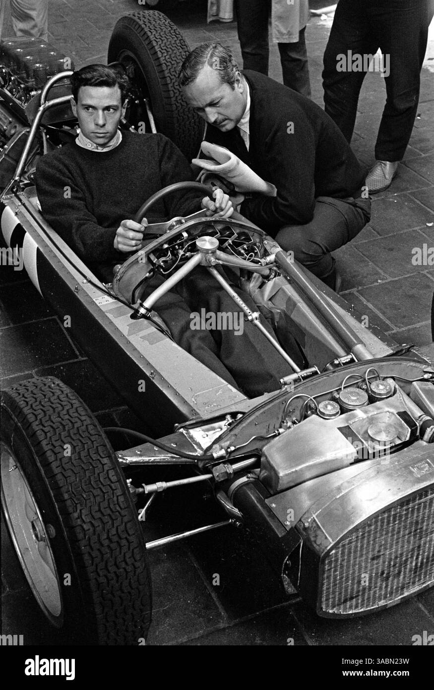 Jim Clark (GBR) tries out his new Lotus 25 Climax for size while Colin ...