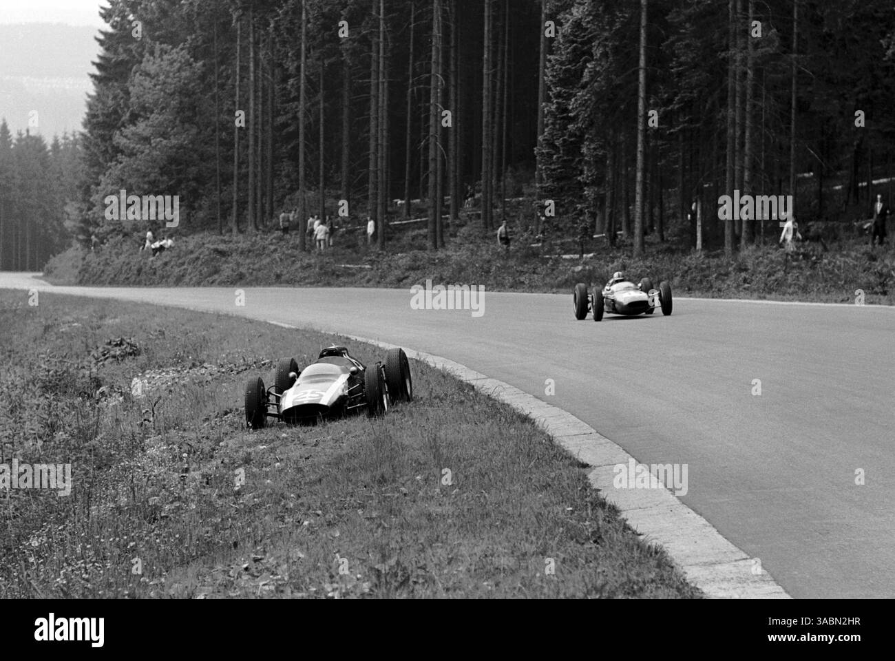 Fifth place finisher John Surtees (GBR) Lola Mk4 passes the stricken ...