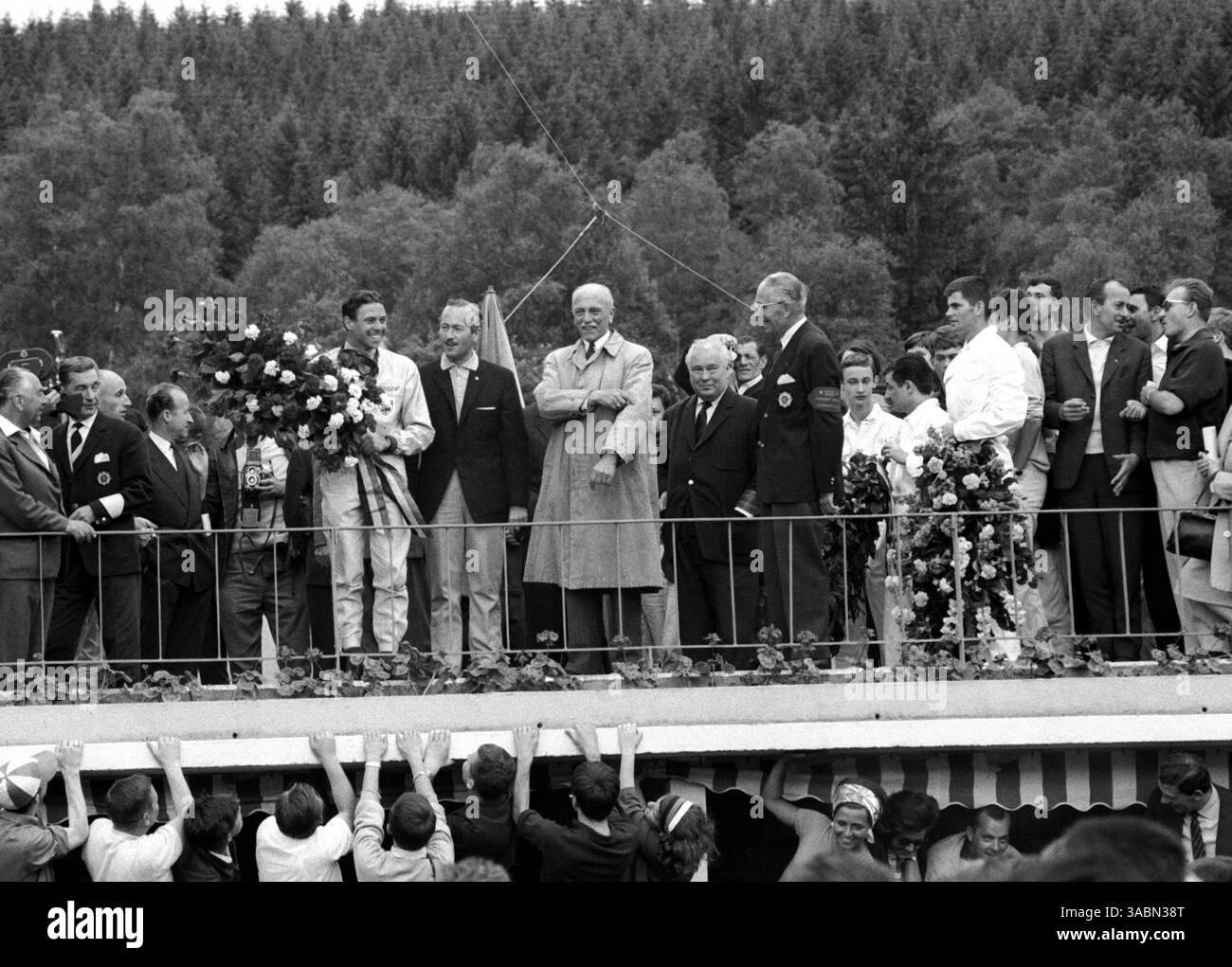 Jim Clark (GBR) Lotus celebrates his victory on the podium with Lotus ...