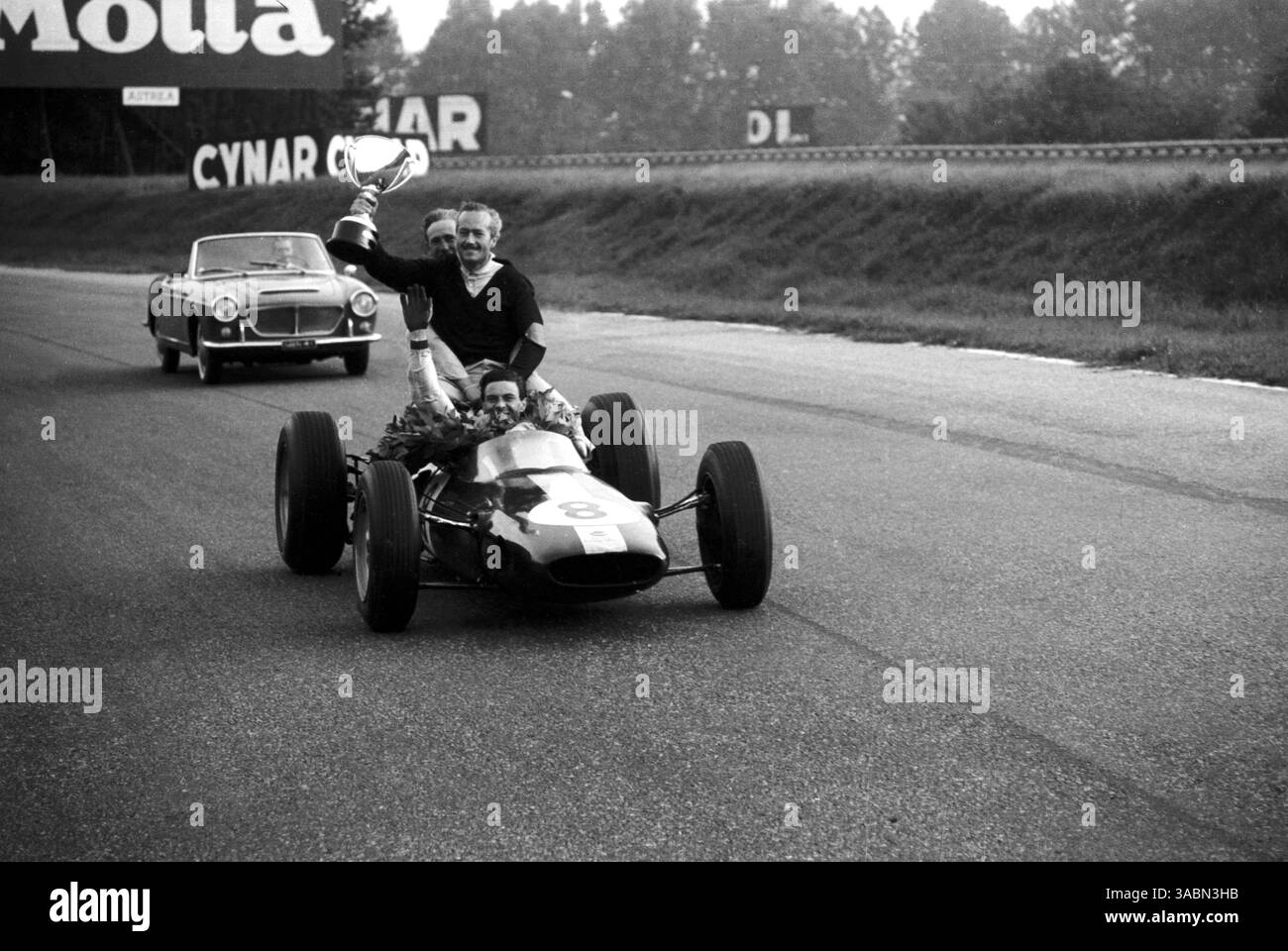 Race winner Jim Clark (GBR) Lotus 25 gives Colin Chapman (GBR) Lotus ...