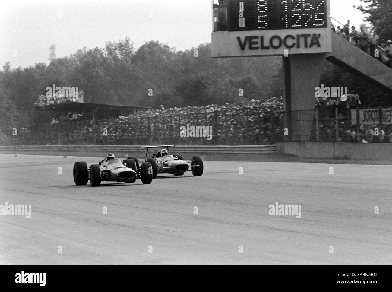 Race winner Denny Hulme (NZL) McLaren M7A leads Johnny Servoz-Gavin ...