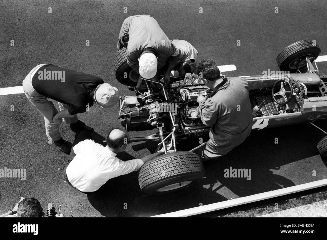 Ferrari mechanics inspect the rear of the Ferrari 158 driven by ninth ...