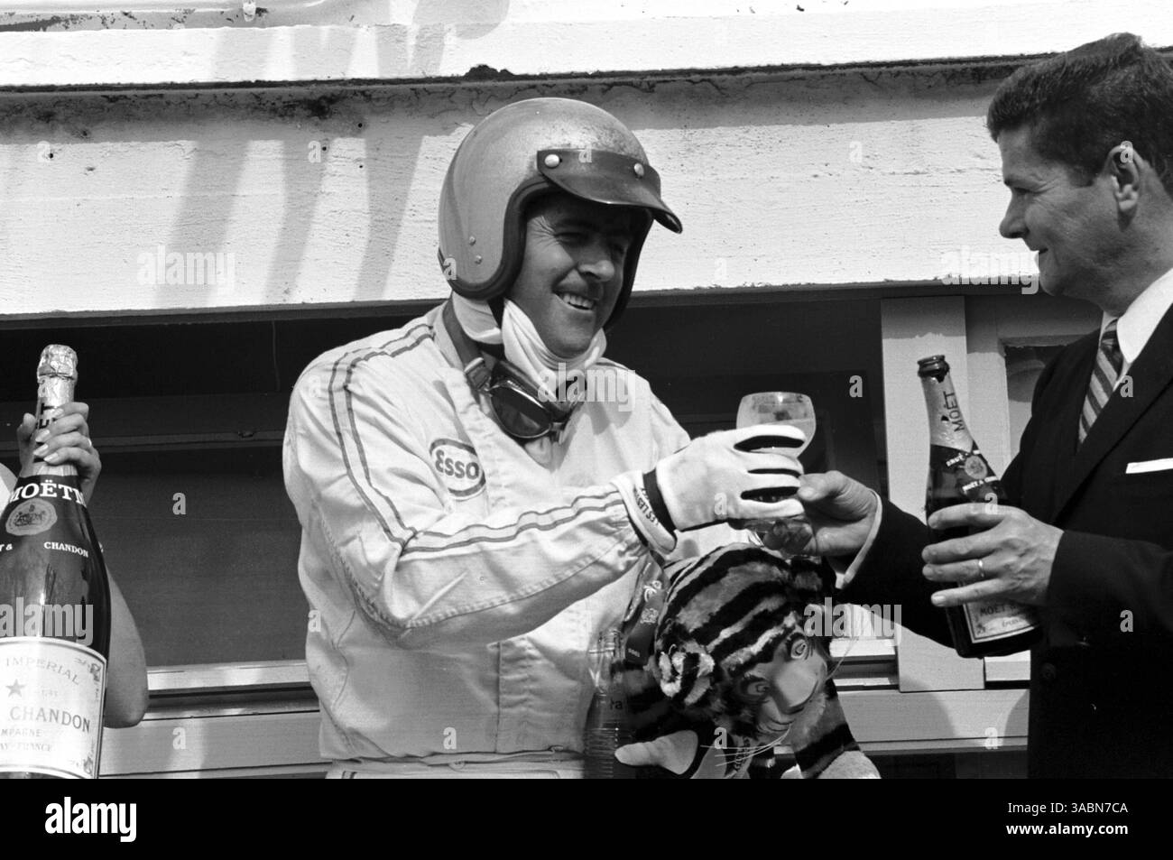 Winner Jack Brabham(AUS) Brabham BT24, accepts a glass of champagne ...