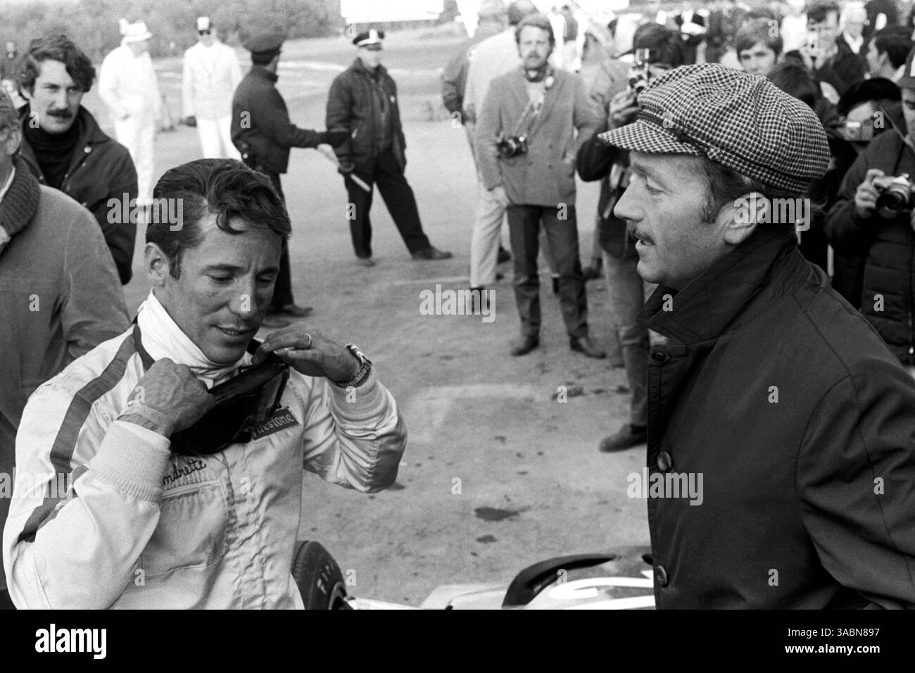 L to R): Mario Andretti (USA) Lotus, with Colin Chapman (GBR) Lotus ...