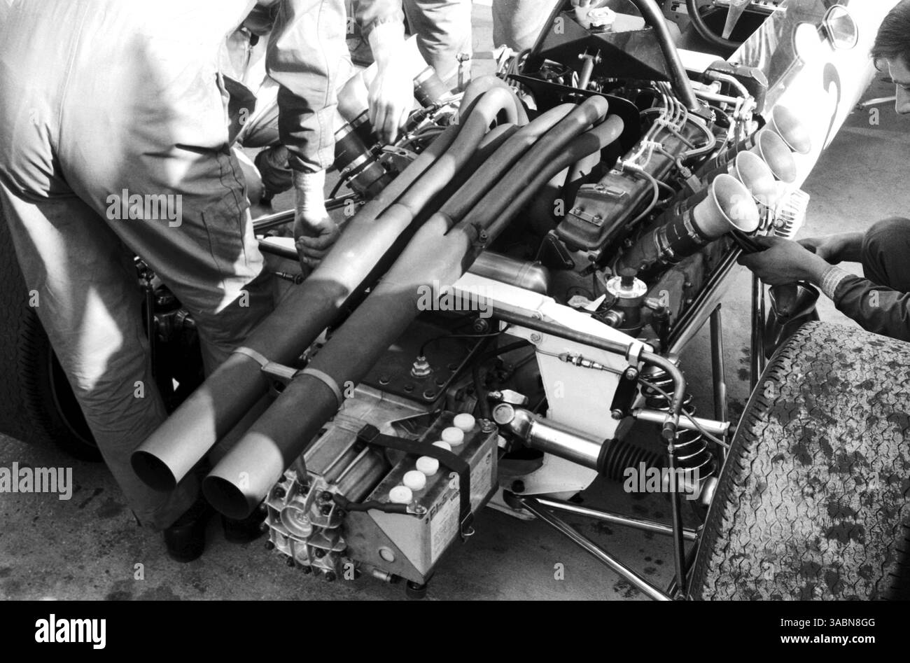 Mechanics work on the McLaren M2B of Bruce McLaren (NZL) that was ...