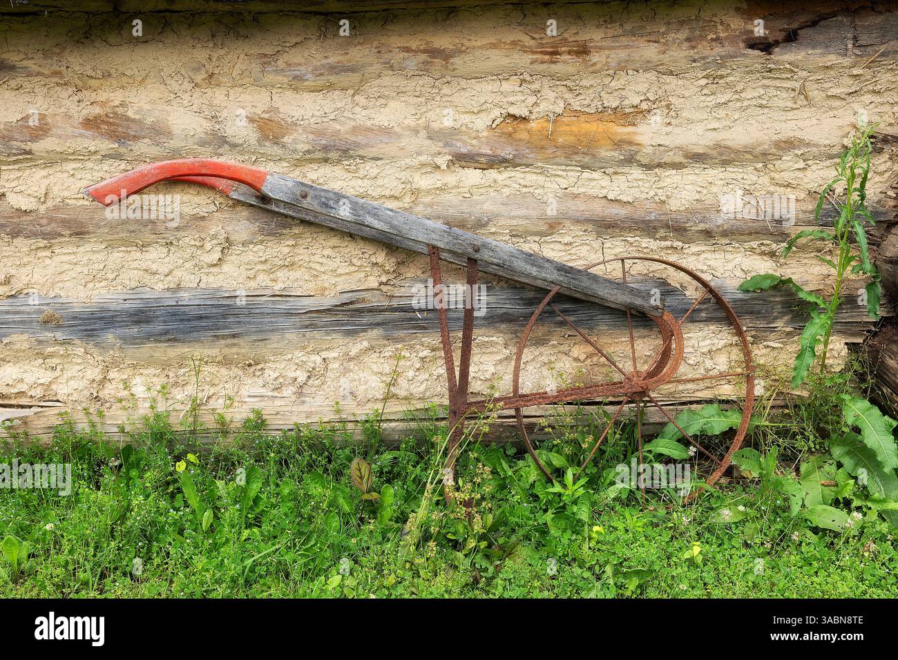 Hand plow leans agains and replica of an old building at Davy Crockett ...