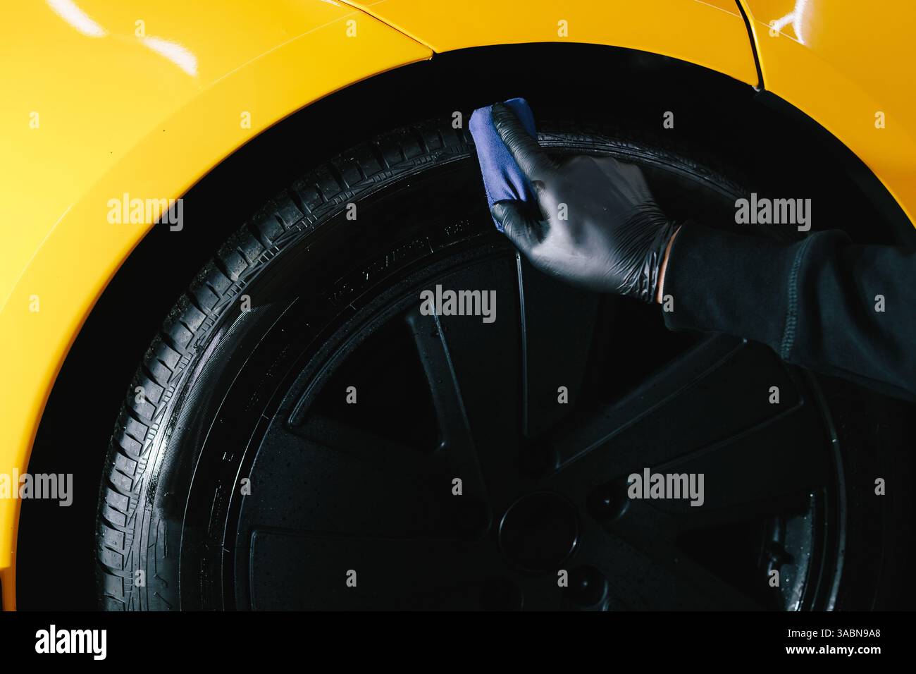 Blackening of tire wheel of car using sponge with chemical blackening ...