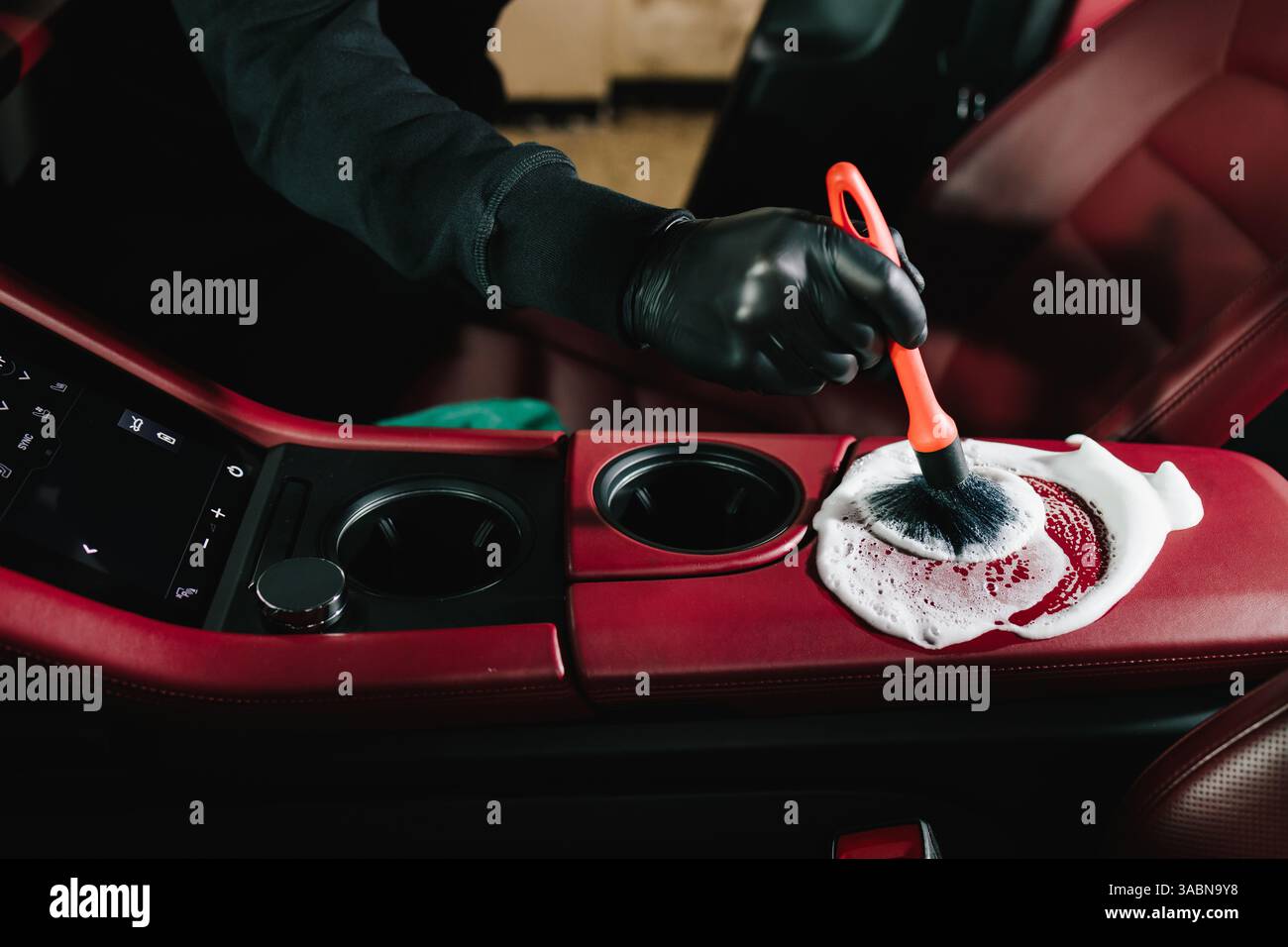 Car detailing process of cleaning leather auto interior with soap foam ...