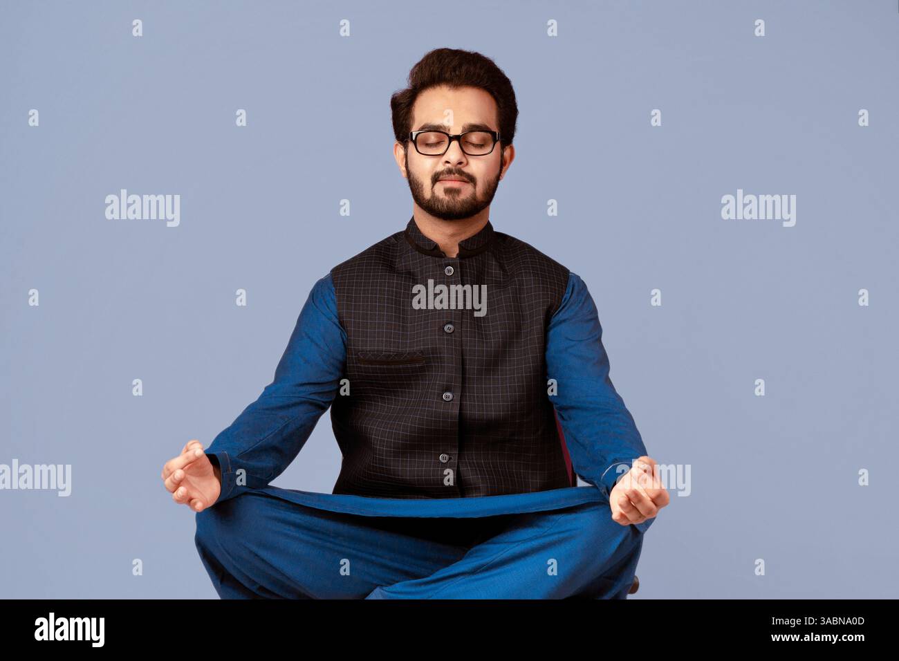 Stress management. Calm Indian man meditating with closed eyes over ...