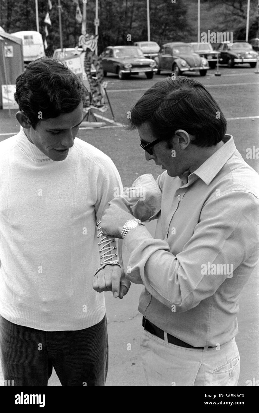 Jackie Stewart (GBR) (right) shows Jacky Ickx (BEL) the splint that was ...