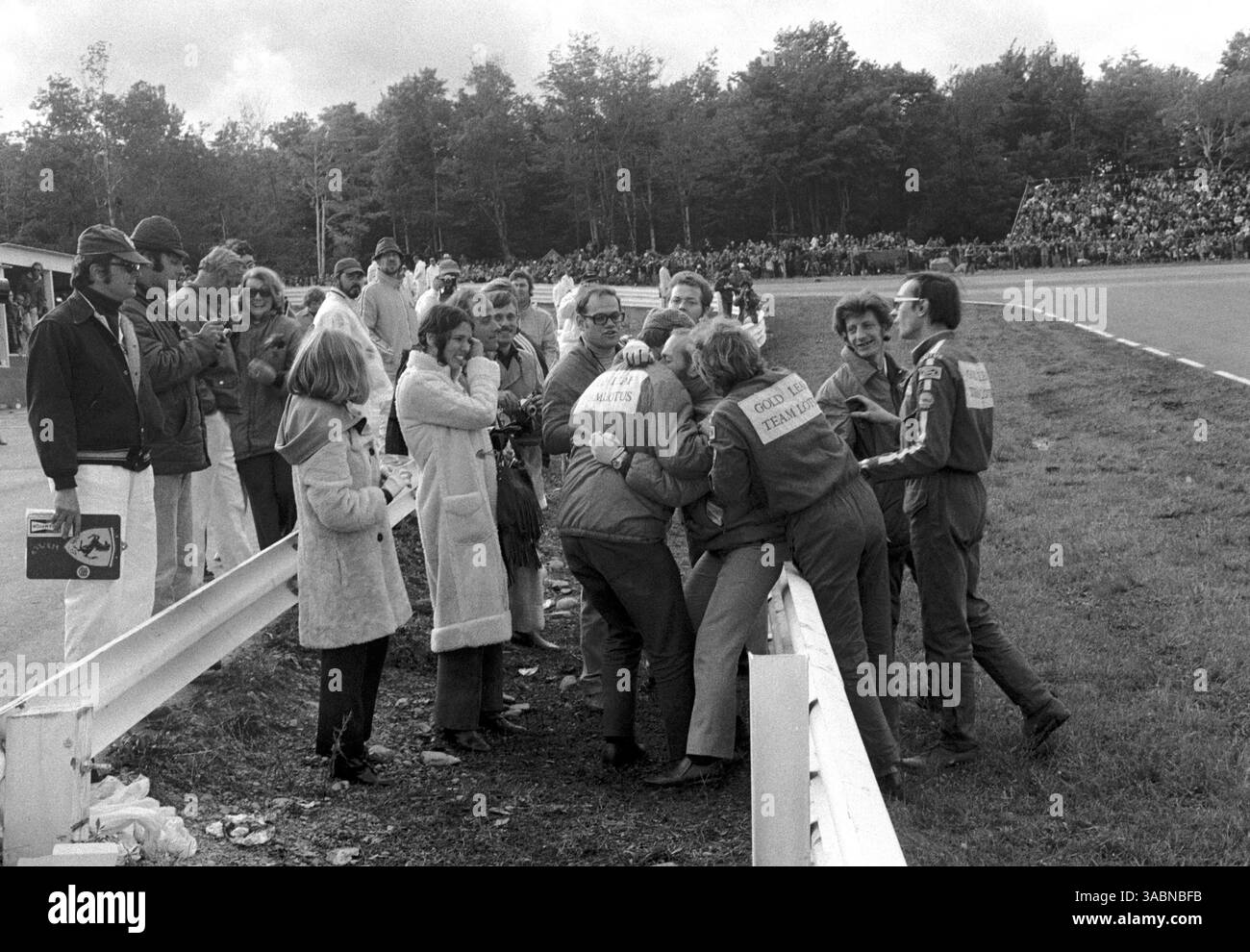 Colin Chapman is embraced by his mechanics after Emerson Fittipaldi's ...