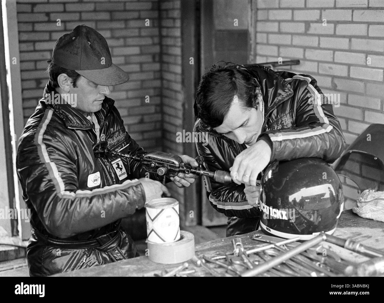 Race winner Jacky Ickx(BEL) makes some adjustments to his helmet before ...