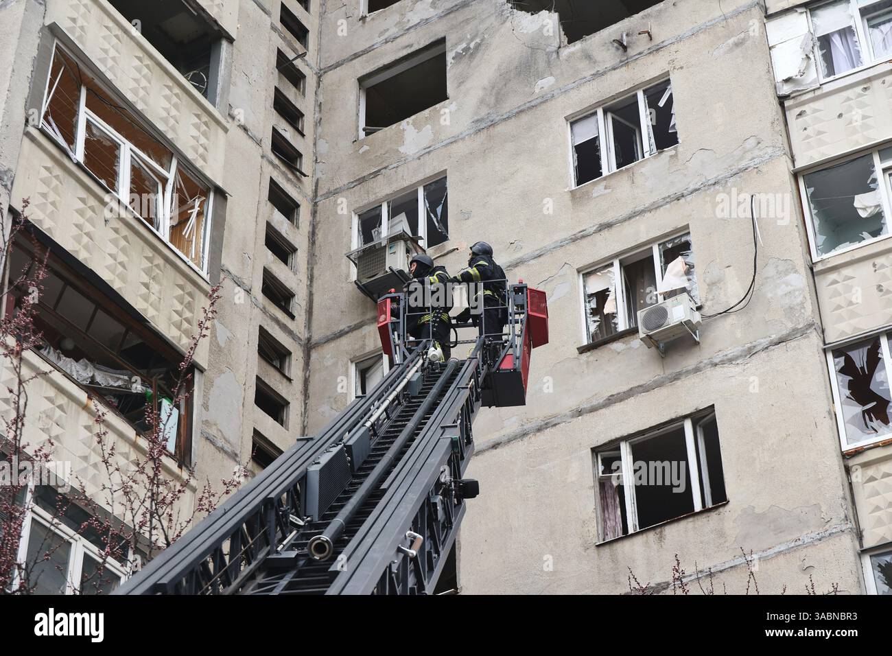 Rescuers use an aerial ladder platform at a 16-storey apartment block ...